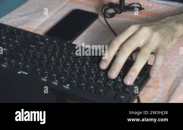 male fingers press the buttons of the keyboard. password entry. concept ...