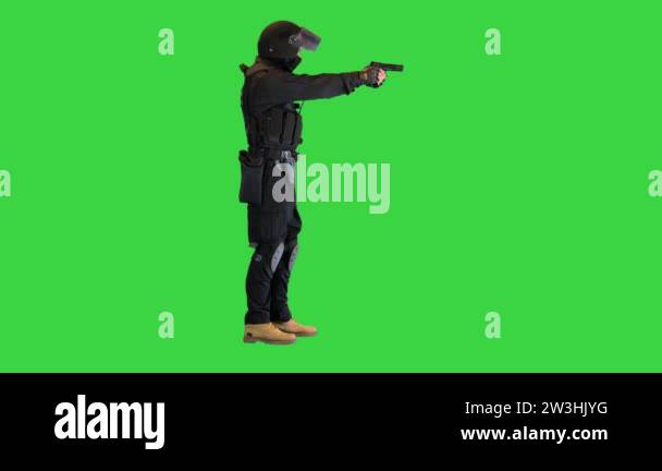 Police tactical unit aiming with a hand gun on a Green Screen, Chroma ...