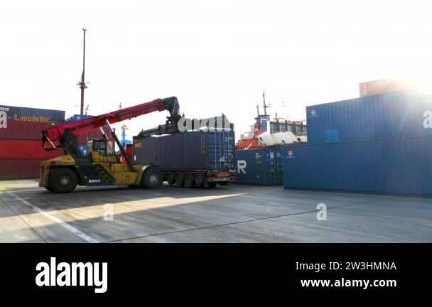 Vladivostok, Russia, 2020 - Vladivostok Commercial Sea Container Port. Reachstacker unloads a ...