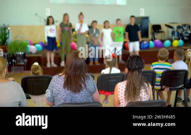 Little children in kindergarten perform on stage in front of their ...