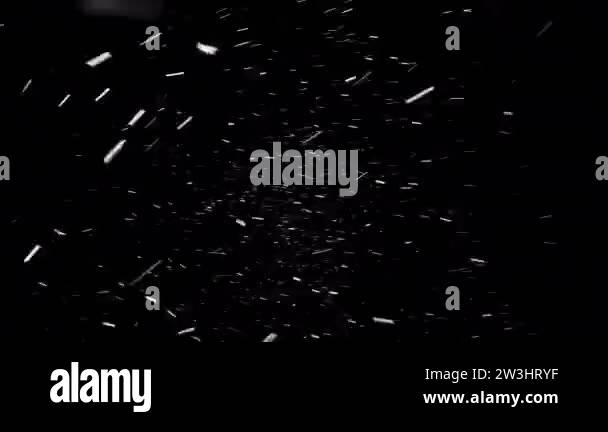 Heavy snow falling from left to right on the black background ...
