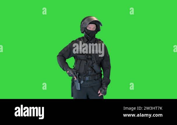 Police tactical officer checking his hand gun and folding hands on a ...