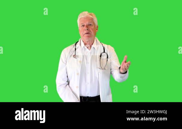 Doctor physician standing and explaining something on a Green Screen ...