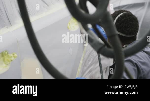 African American male car mechanic working in a township workshop ...