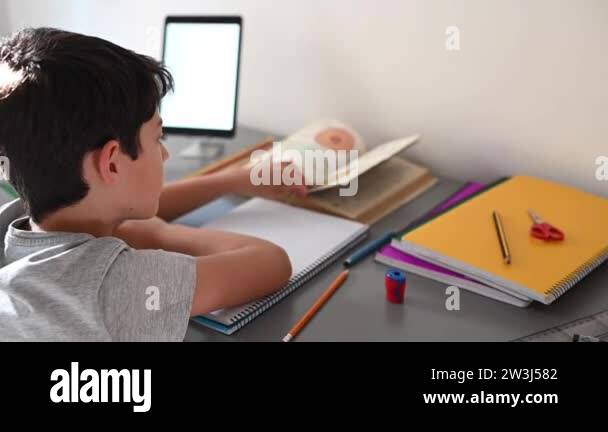 Stress kid doing homework.Boy at study table doing homework with stress ...