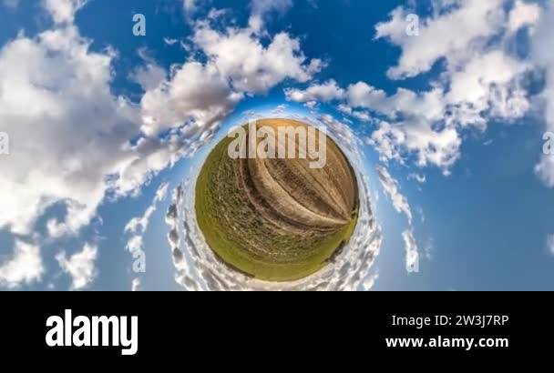 little planet rotates in beautiful blue sky with fluffy clouds. tiny ...