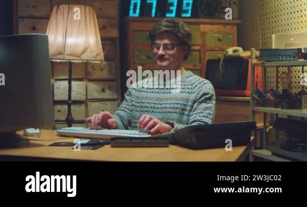 Caucasian male nerd in glasses with mustache sitting at desk in retro ...