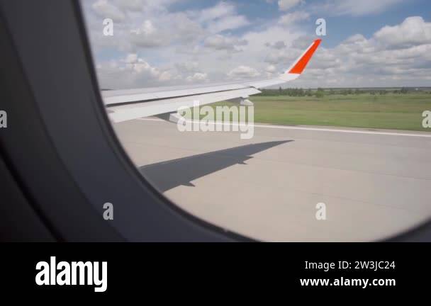 White wing of airplane taking off. Aerospace vehicle going from the ...