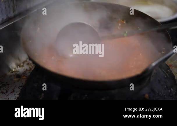 Cooking red chutney gravy in an Indian pan - Kadhai for Tibetan momos ...