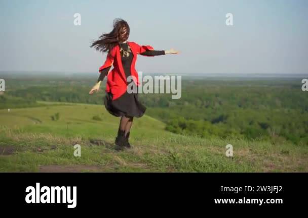 Georgian woman dances national dance in red national dress on the green ...