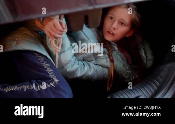 Tied up with a rope victim girl child lies in the trunk Stock Video ...