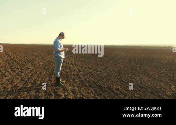 farmer man with tablet in the field. male agronomist checks the quality ...