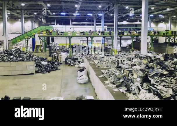 Big recycling center with piles of trash. Trash, e-waste, electronic garbage recycling factory ...