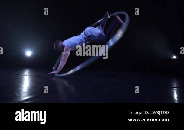 Circus artist shows concentration and balance while spinning on a Cyr ...