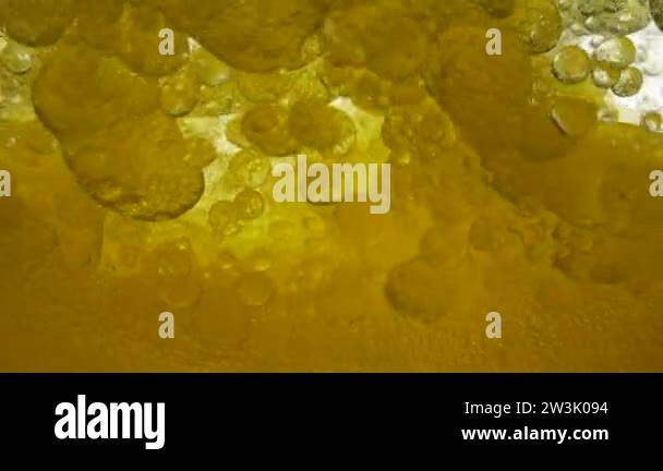 Bubble structure of air of sunflower oil on a white moving background ...