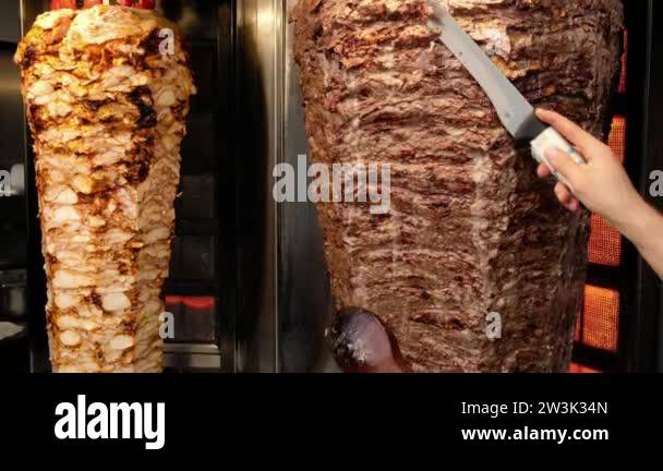 Shawarma meat being cut before making traditional Turkish Doner Kebab ...