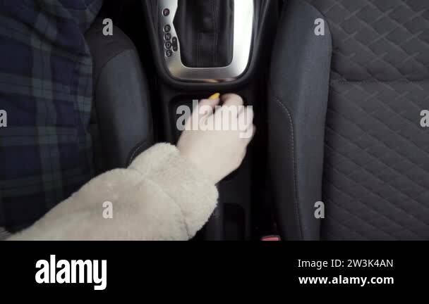 Driver woman controlling automobile and pulling handbrake. Action ...