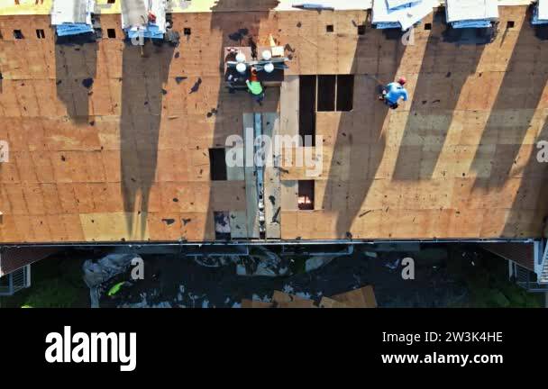 Removal of old roof and replacement with new roof shingle being applied ...