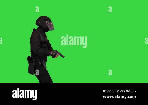Special police unit walking in and shooting from hand gun on a Green ...