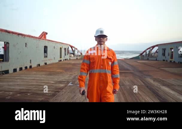 Filipino deck Officer on deck of vessel or ship , wearing PPE personal ...