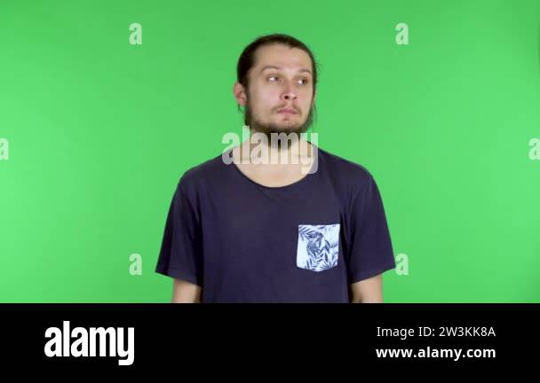 A portrait of a young, darkhaired, bearded man who looks around and recoils abruptly when he ...