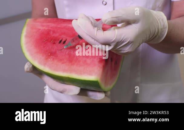 Scientist female injecting watermelon with syringe Stock Video Footage ...