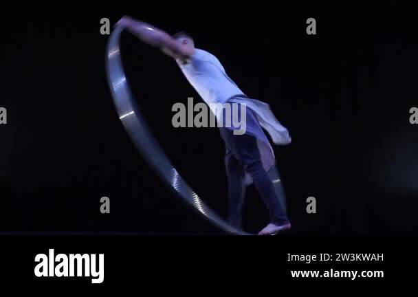 Circus artist shows concentration and balance while spinning on a Cyr ...
