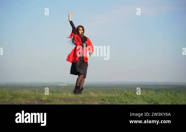 Georgian woman dances national dance in red national dress on the green ...