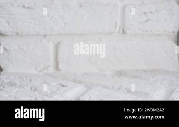 Removable jaw in a glass, close-up. A man's hand puts false teeth in a ...
