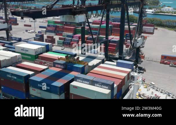 Close up vie on crane lifting shipping container with harbor on motion ...