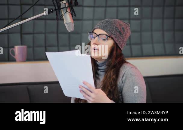A female voice actor recording animated voices into a professional ...