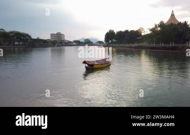 cinematic shot of boats carrying passenger across sarawak river in ...