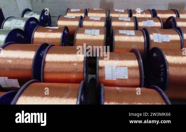 Copper wires with spools, span over coils with copper wire. Coil ...