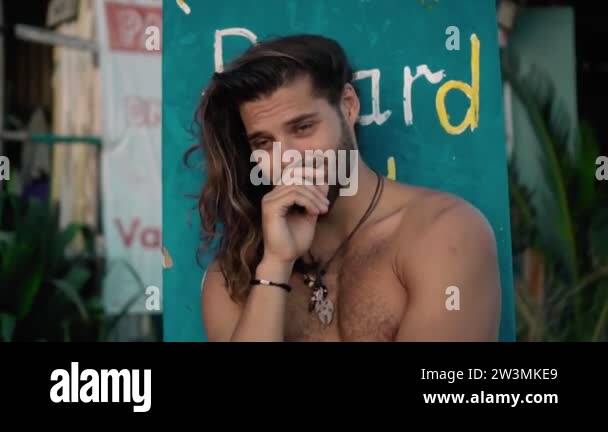 Young handsom European guy brunette with long hair with a wrapped ...