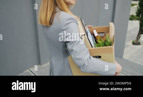 Vew over shoulder of Caucasian sad businesswoman walking outdoor with ...