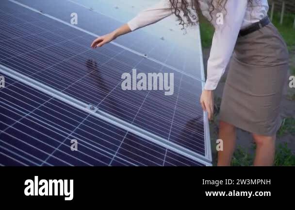 Engineer checks solar panel. Hand touches solar panel. Solar panels on ...
