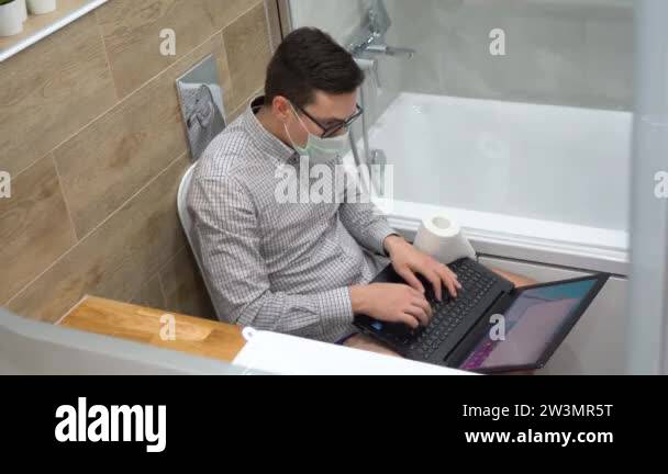 Reflection in mirror. Male freelance programmer wear protective face ...