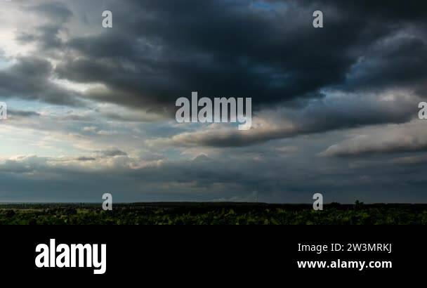 Time lapse of dramatic rain cloud rolling over the city with giant ...