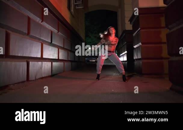 young dancer performs modern choreography, street dance in the arch at ...