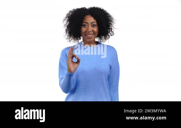 African woman showing Ok sign over white studio background. Positive ...