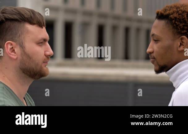 The black guy and the white man are staring at each other. Concept of ...