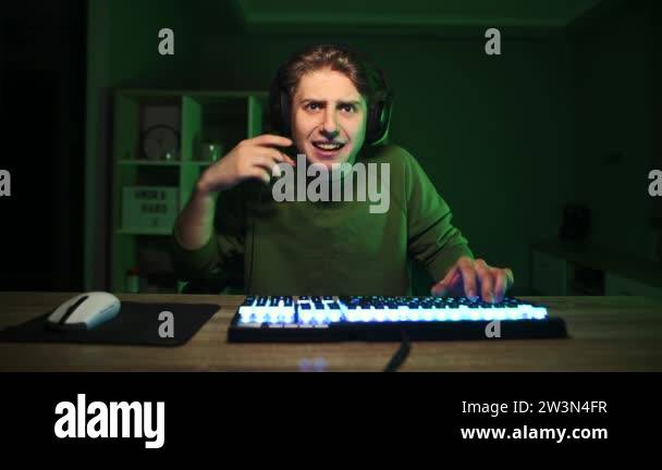 Young man loses a video game and covers his face with shame. Sad gamer ...