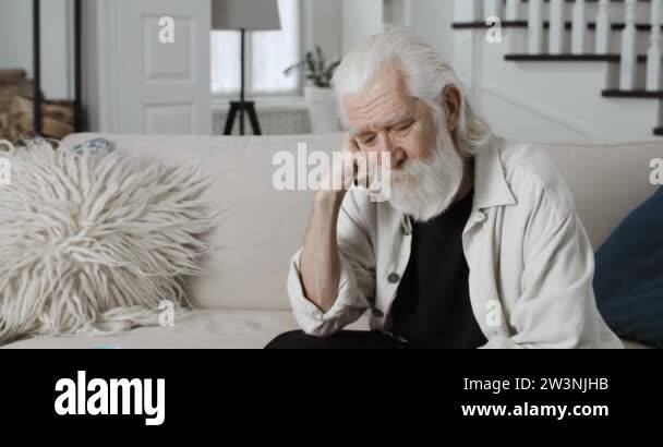 Crop view of thoughtful male retiree thinking while propping head ...