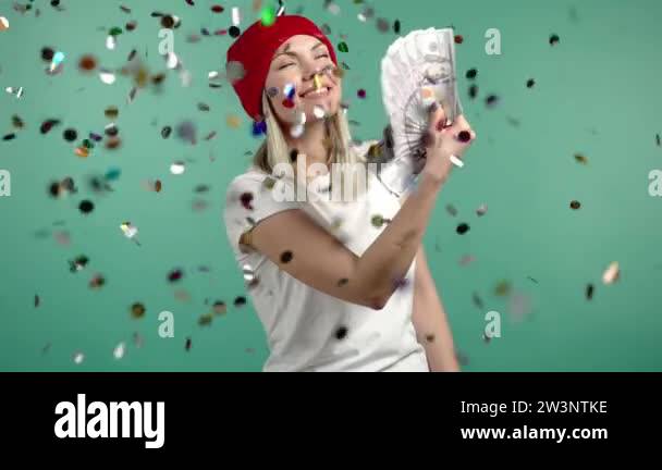 Happy excited woman under confetti rain with cash money - USD currency ...