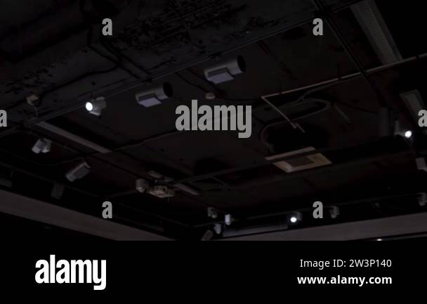 Bottom view of a black ceiling of a hall lighting with spotlights ...