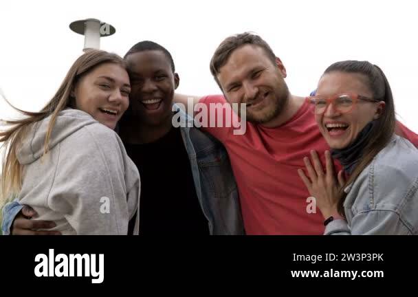 Four people of different nationalities stand embracing. Concept of ...