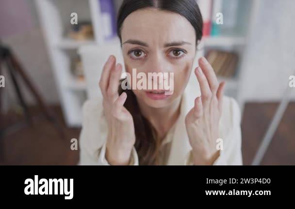 Face of desperate overwhelmed young woman crying in office at workplace ...