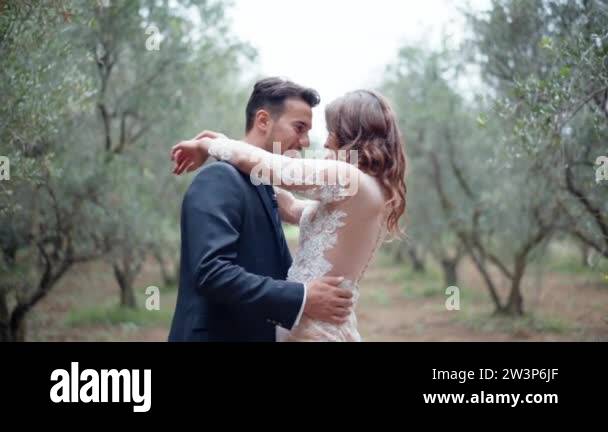 Couple in love cuddling among amazing olive trees, married couple ...