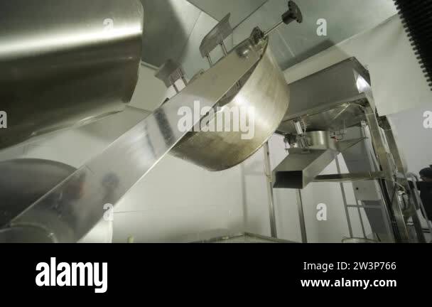 Production of potato chips and snacks. Industrial deep frying machine ...