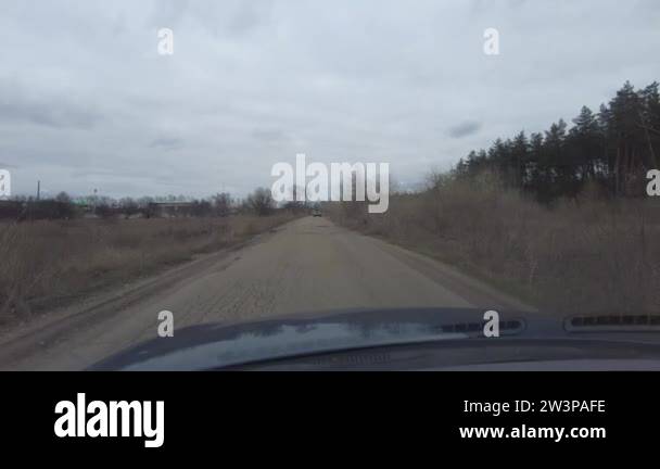 driving in a car on a bad road. Pit on the asphalt caused by bad ...